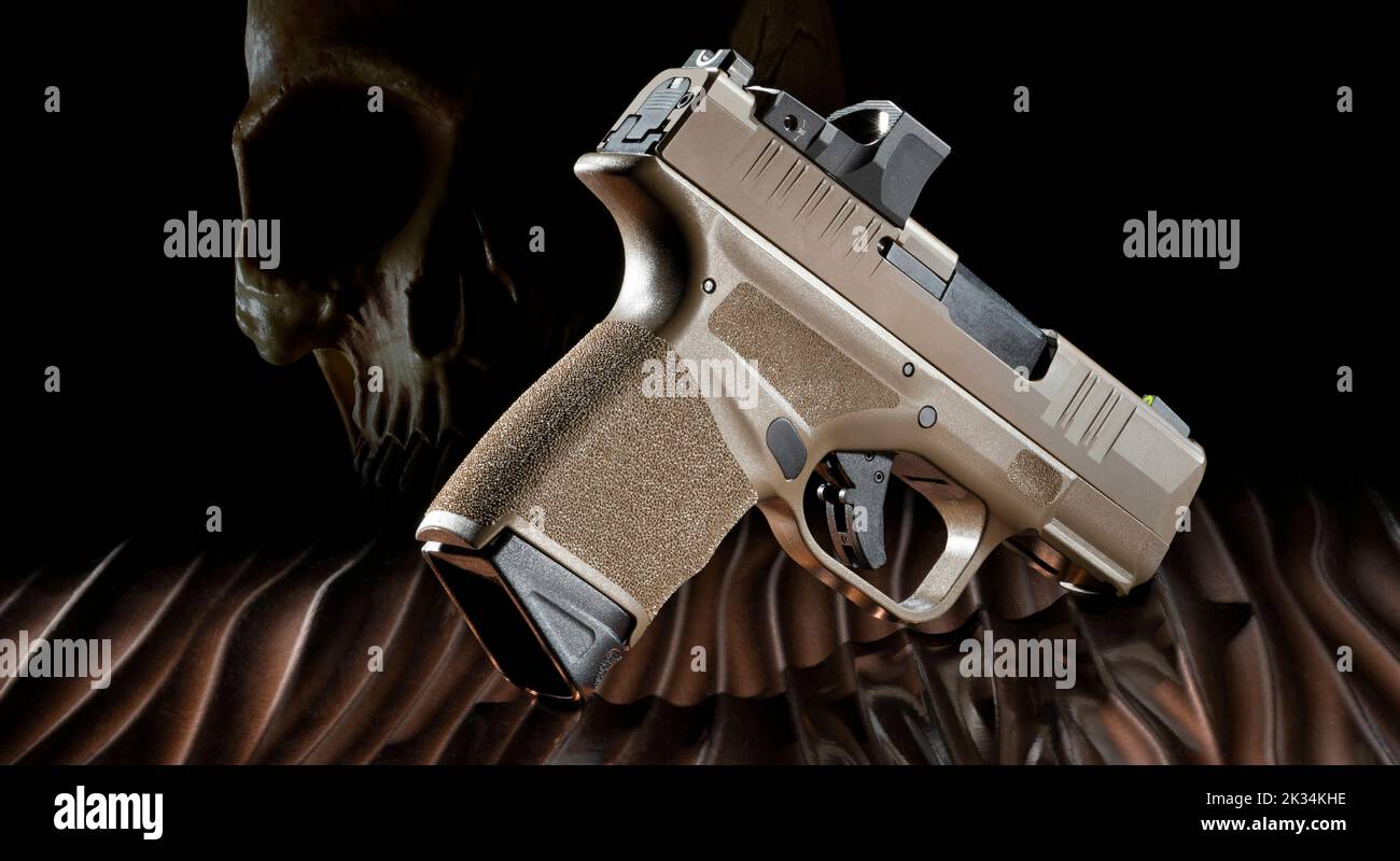 Pistol with skull behind for a ghost gun on a copper surface Stock ...