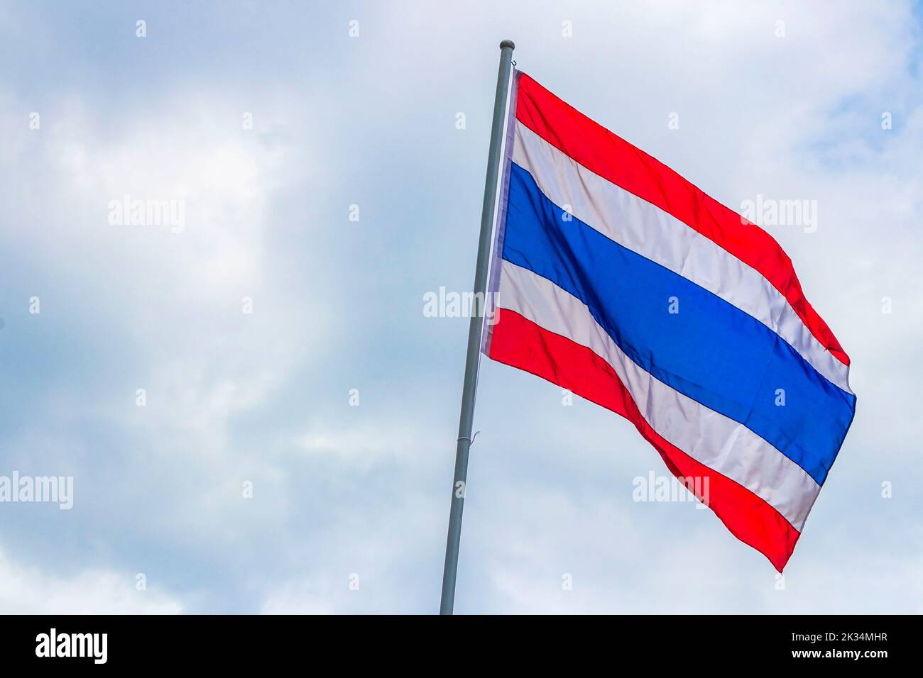 Thai flag flags in red white blue colors blowing in the wind in Sakhu ...