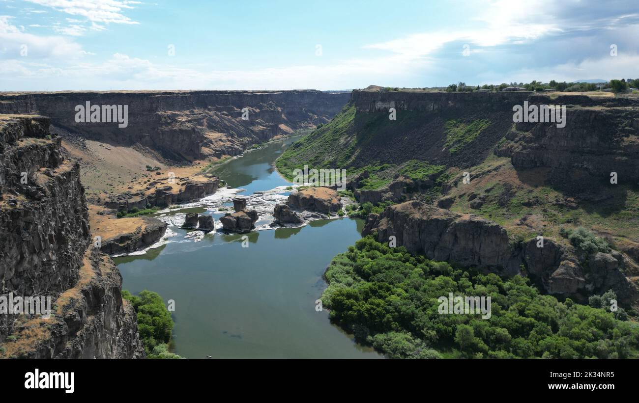 An aerial view of the river surrounded by rocks and shrubs Stock Photo ...