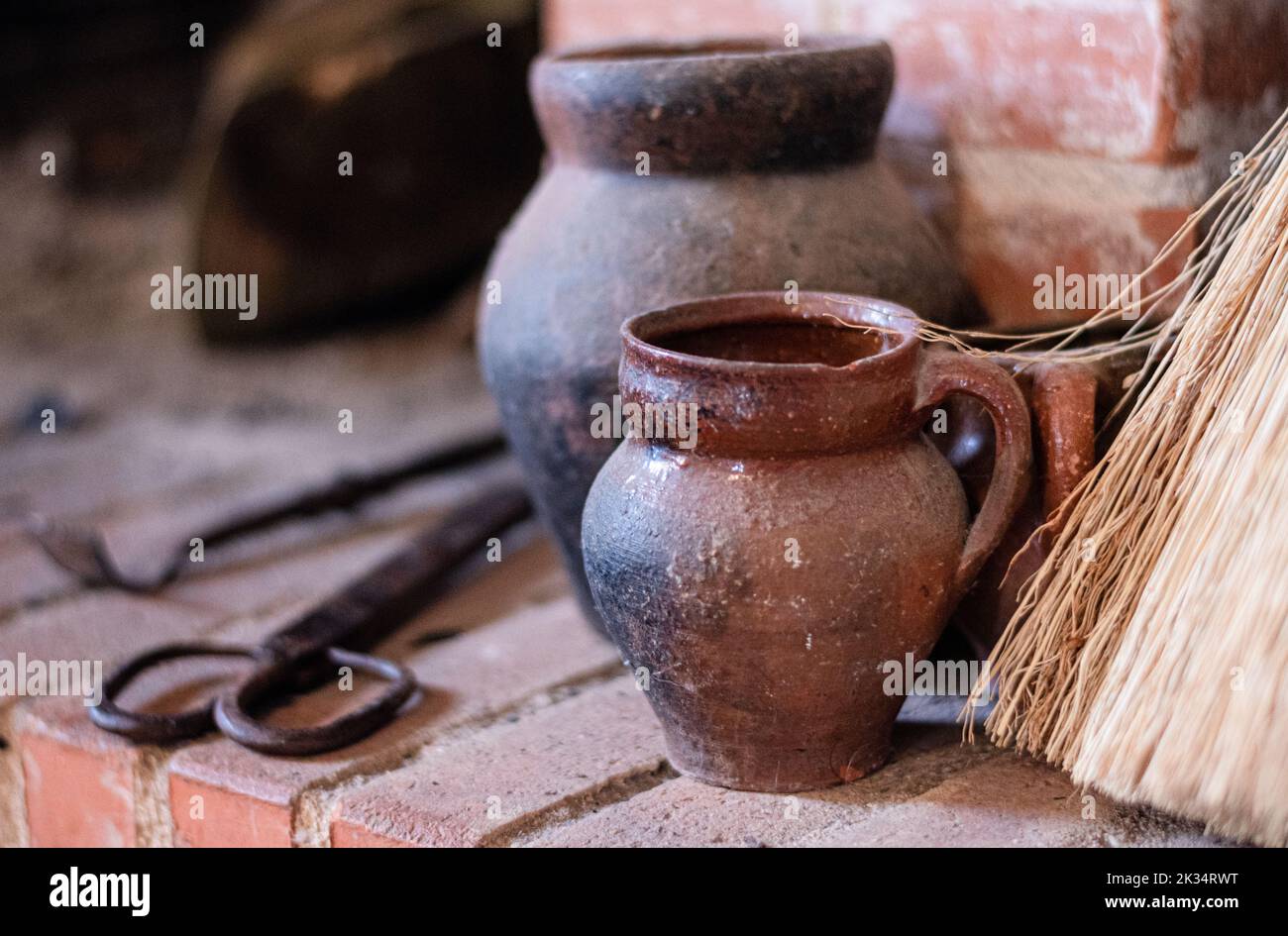Still life. Ceramic pots next to a fireplace and a broom Stock Photo ...