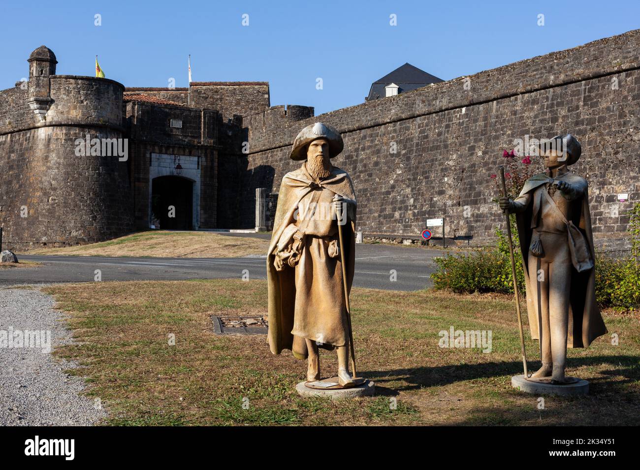 Pilgrims statue near the fortified medieval walls of the French town ...