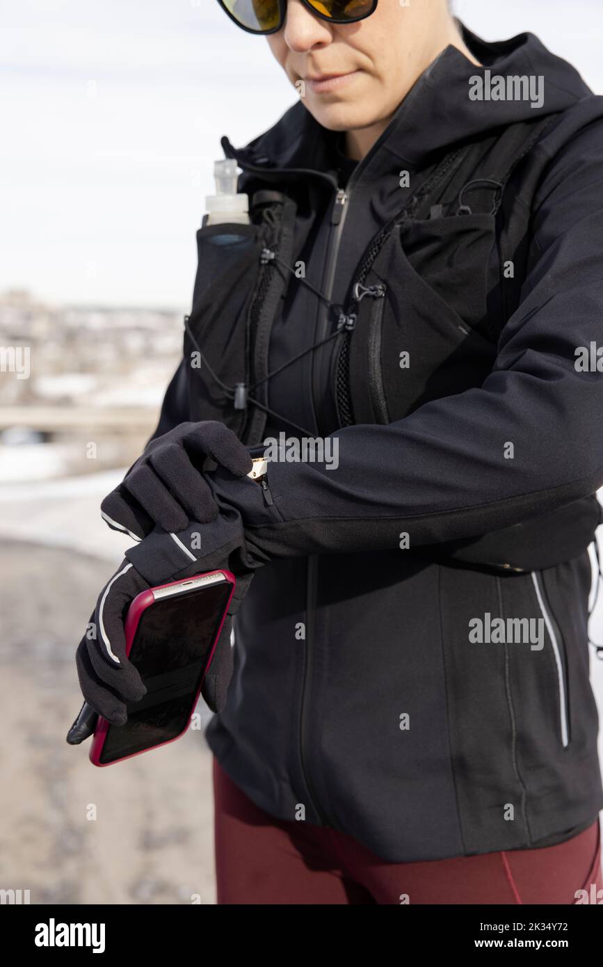 Female runner checking smartwatch Stock Photo - Alamy