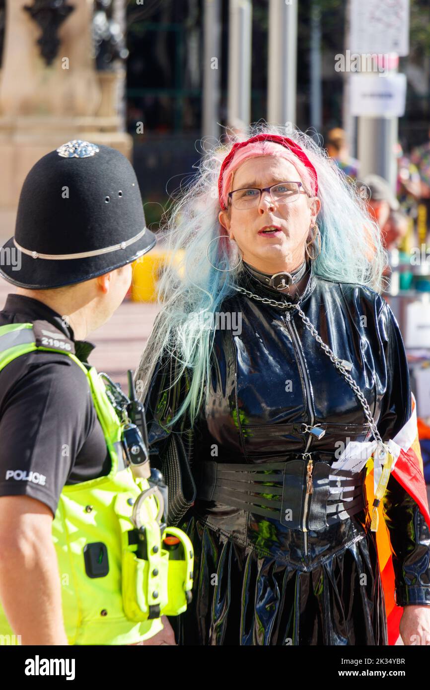 trans woman in drag with police officer at Gay Pride parade protest ...