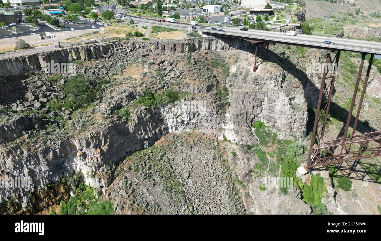 A bird's eye view of a bridge going over a steep cliff on a sunny day ...