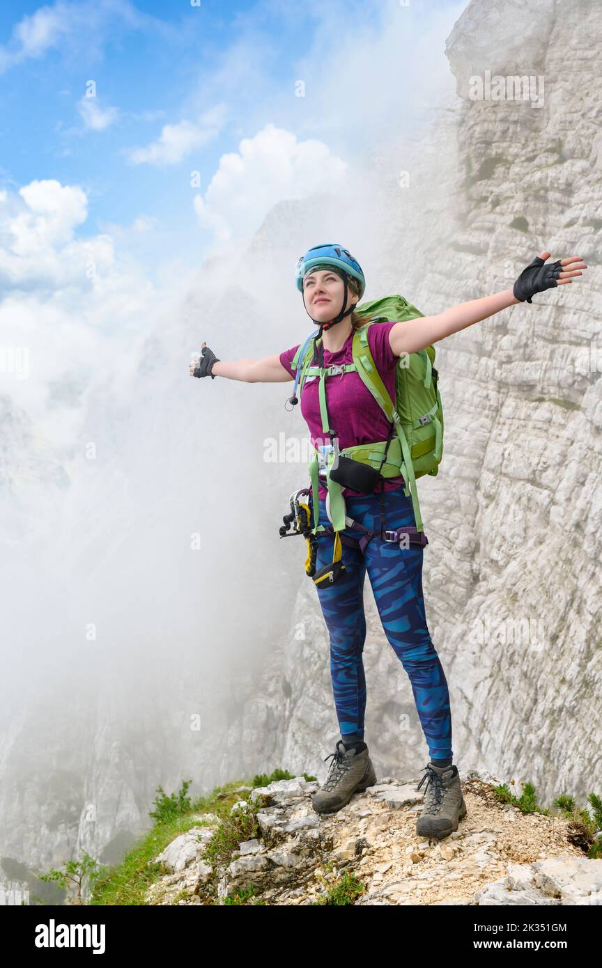 Mountaineer woman enjoying a amazing view from height of Triglav ...