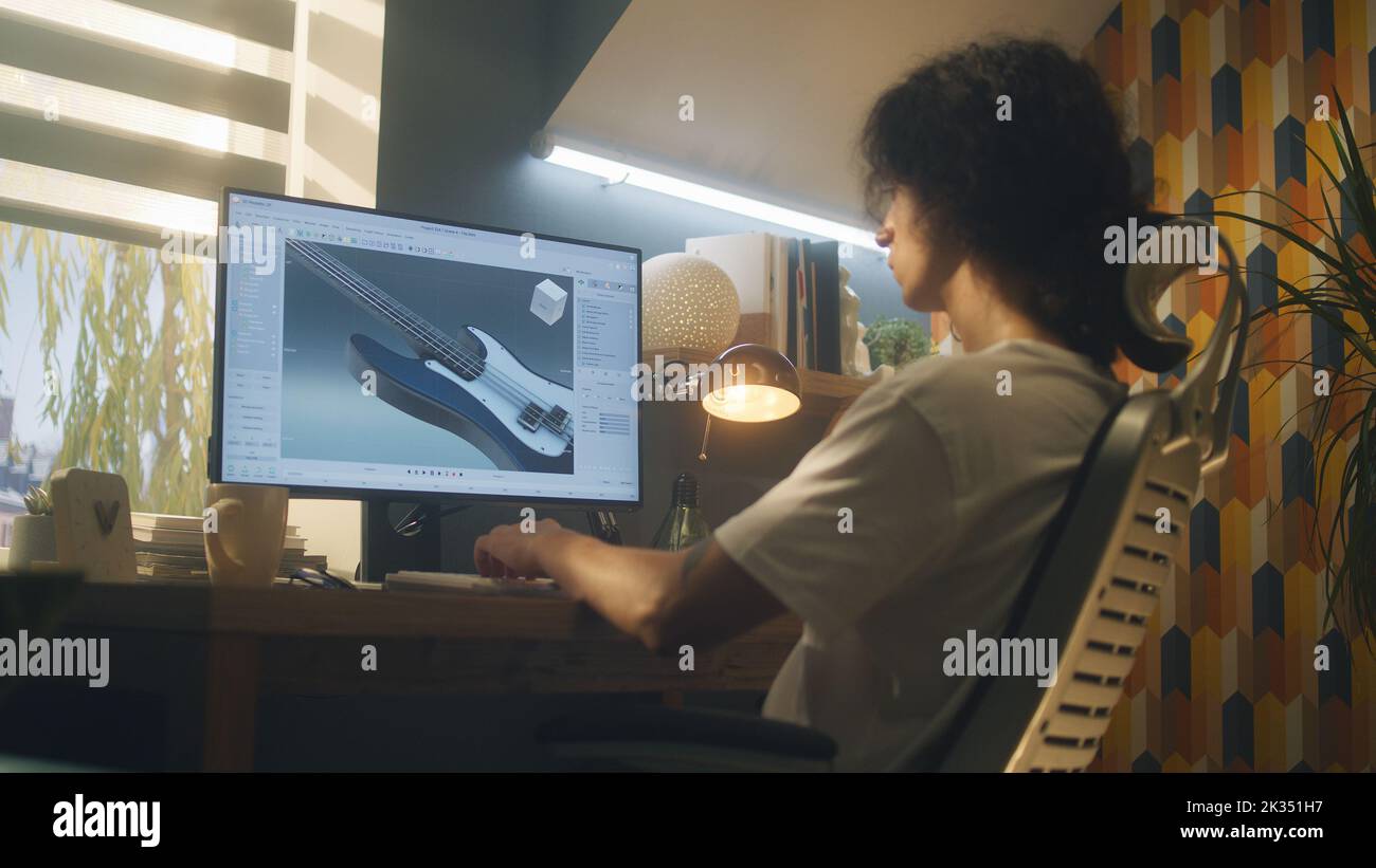 Young Guy Creating 3d Prototype Of Guitar Using Modern Personal