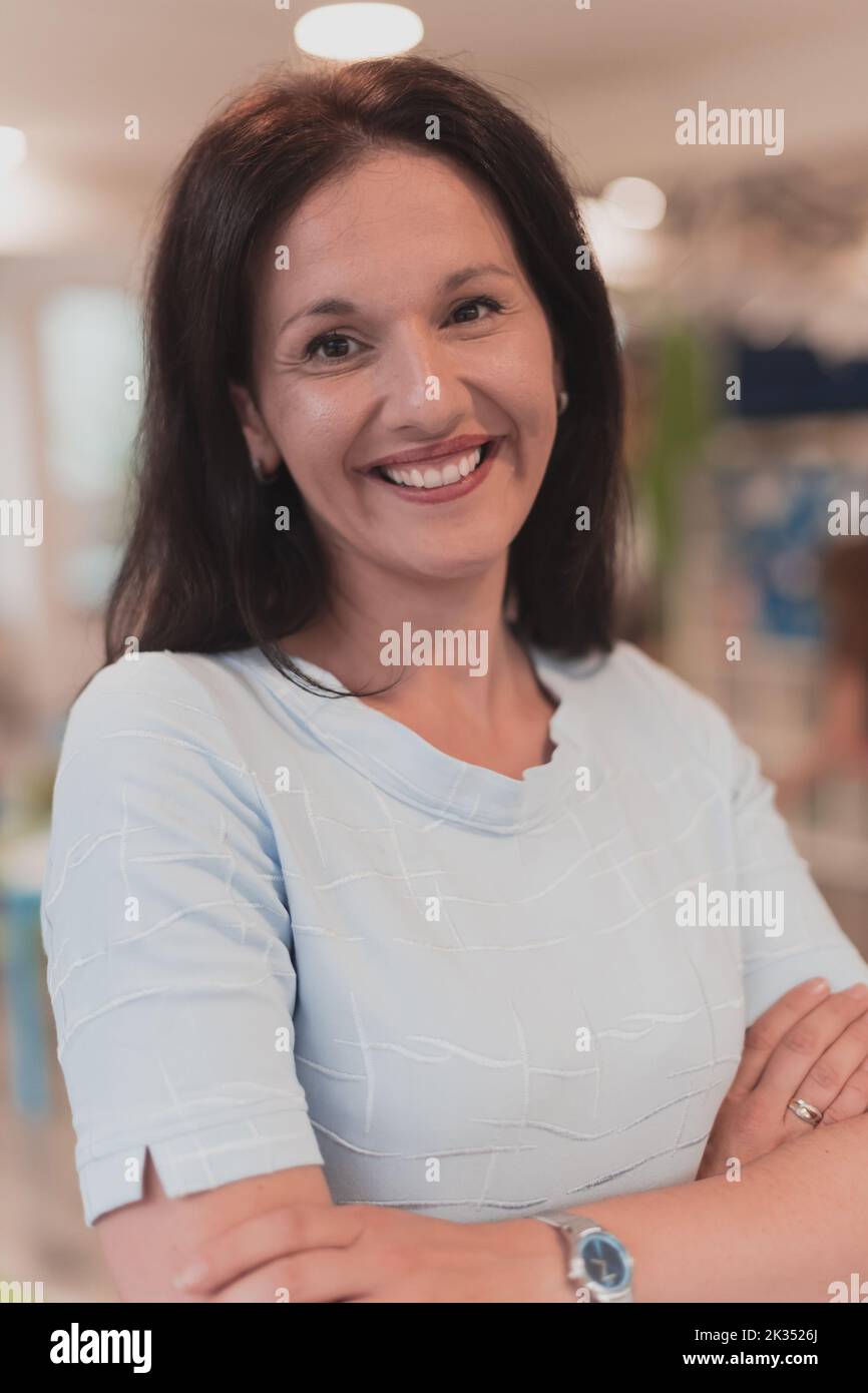Portrait of a teacher in a preschool institution, in the background of ...