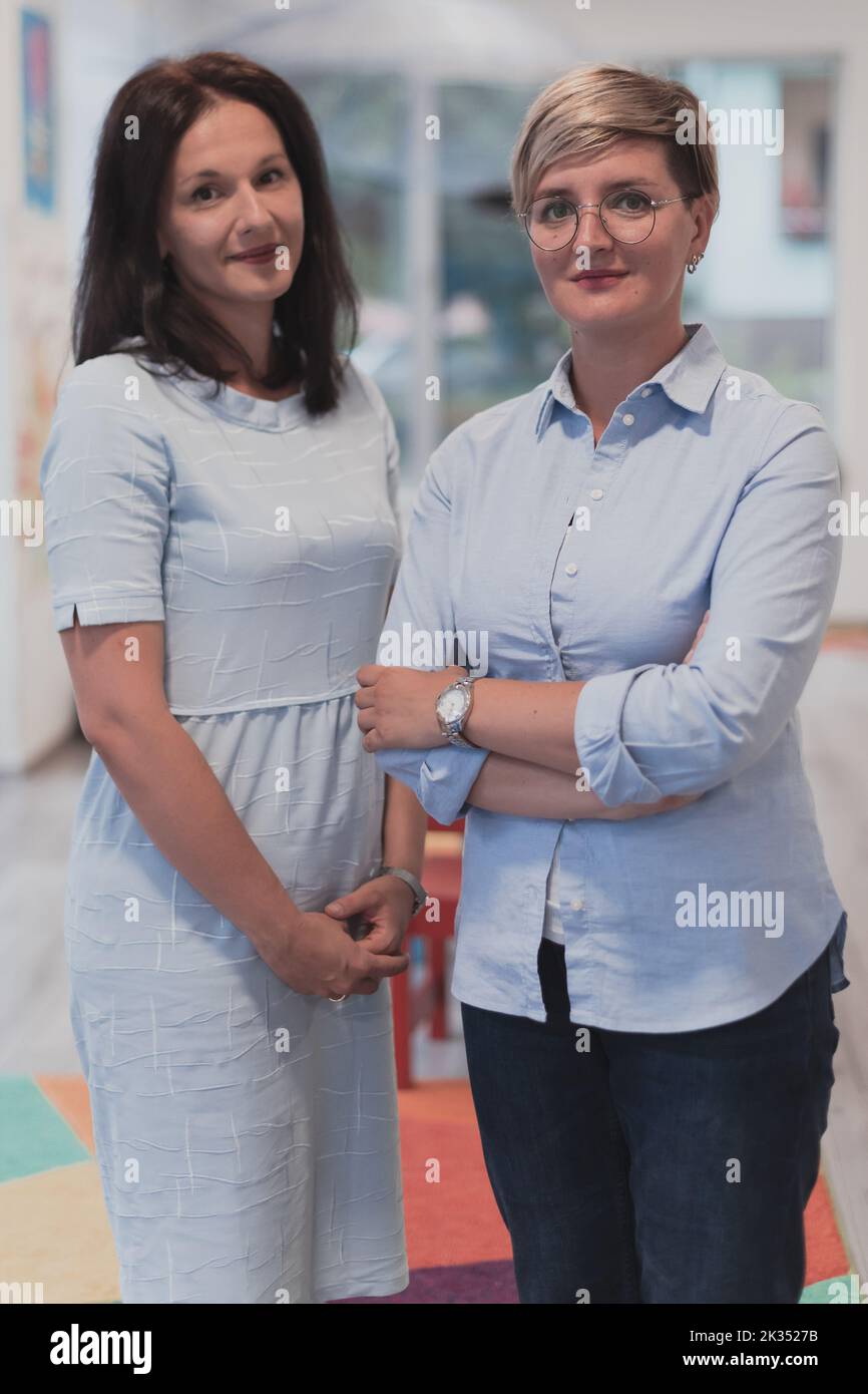 Portrait of a two teacher in a preschool institution, in the background ...