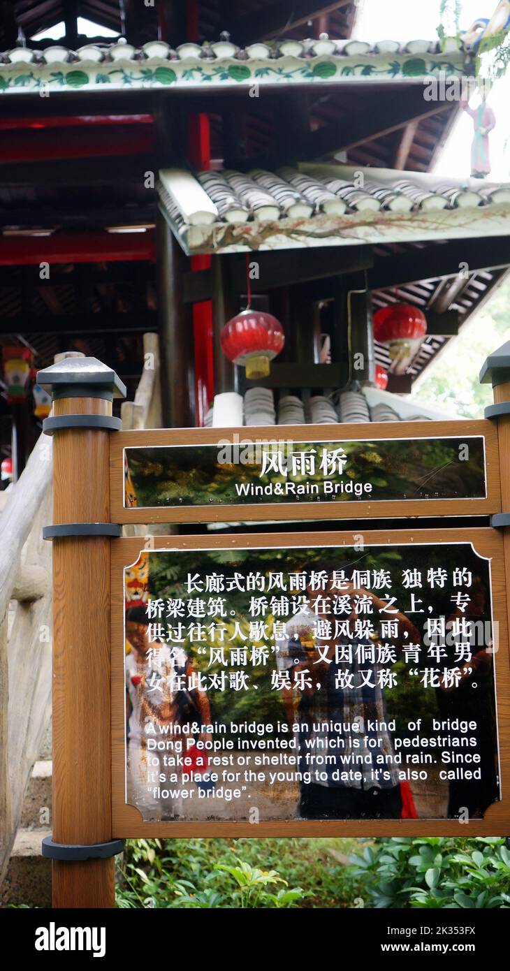An informative board in chinese and english in front of a building in ...