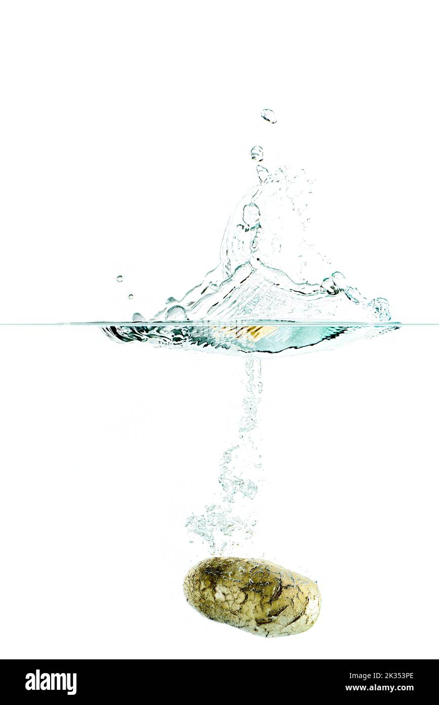 A potato falling into water splash on a white background Stock Photo ...