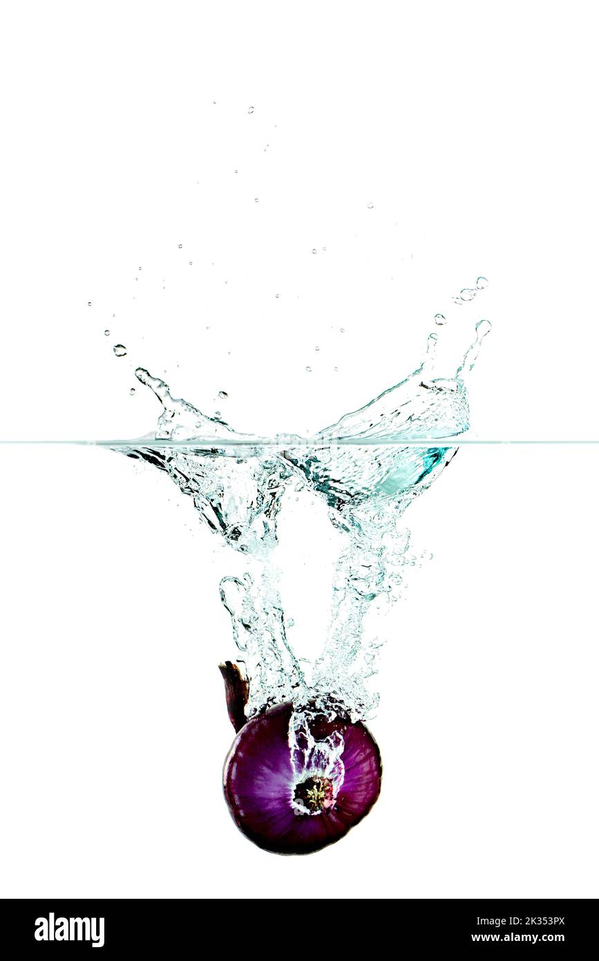 An Onion falling into water splash on a white background Stock Photo ...