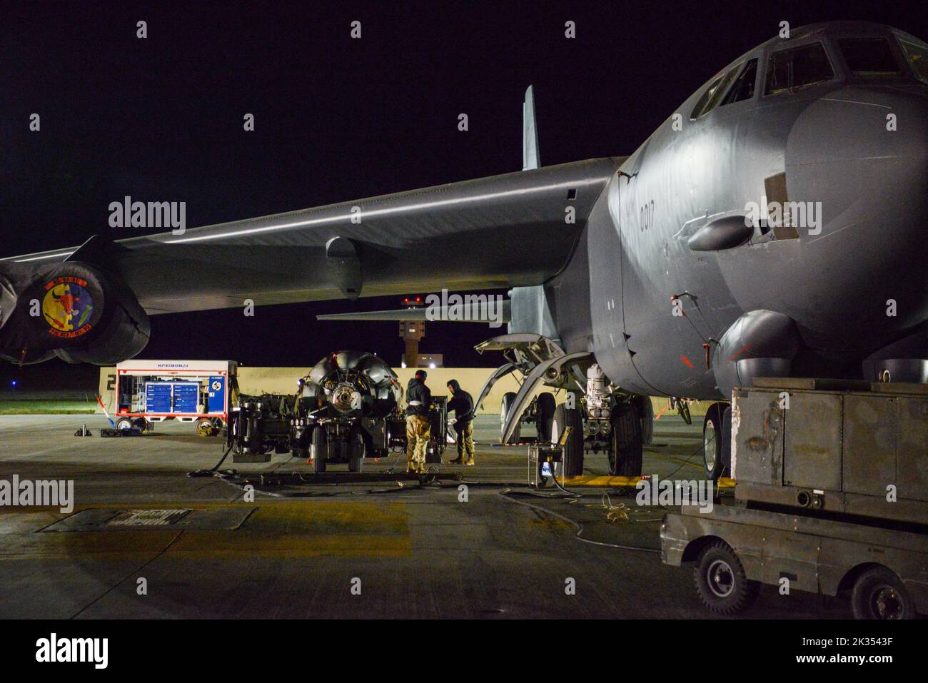 Airmen from the 705th Munitions Squadron load a B-52H Stratofortress ...