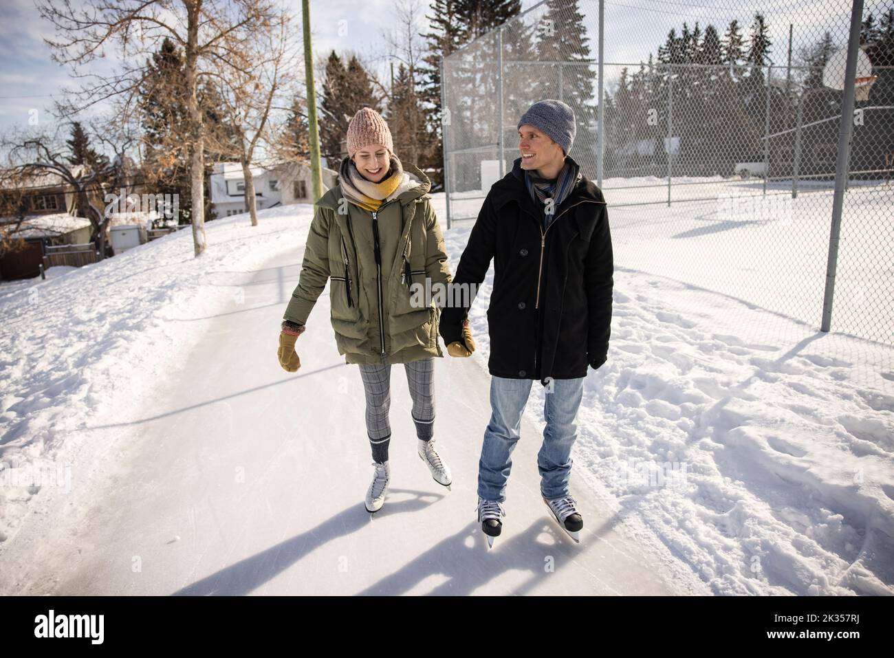 Couple holding hands on ice hi-res stock photography and images - Alamy