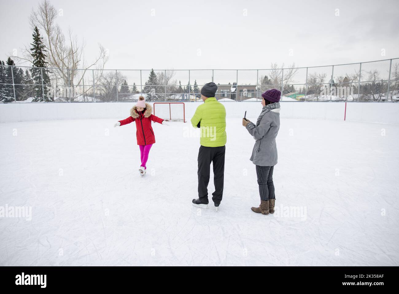 Parents watching daughter skate hi-res stock photography and images - Alamy