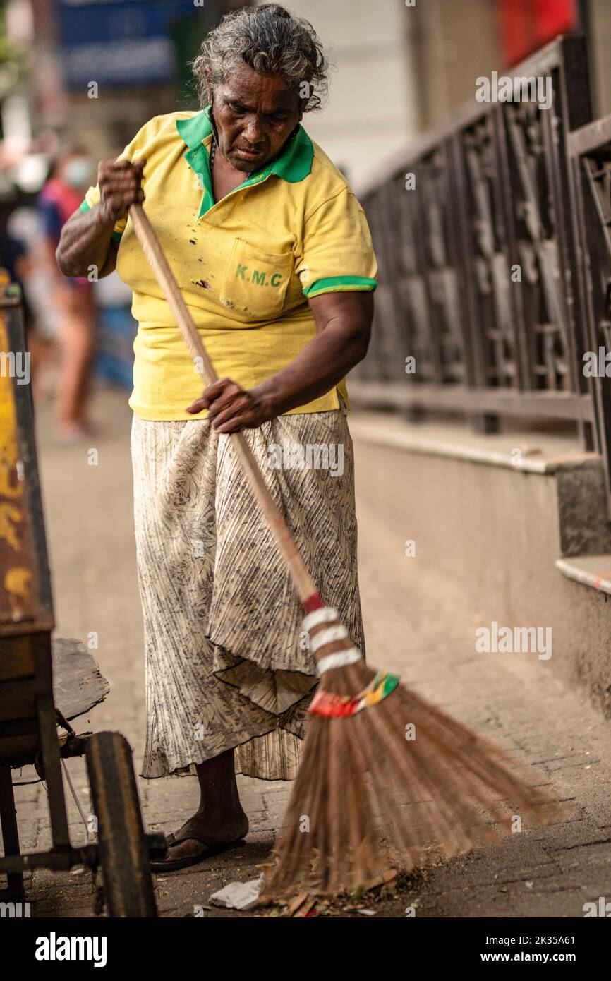 A Poor lady cleaning the streets Stock Photo - Alamy