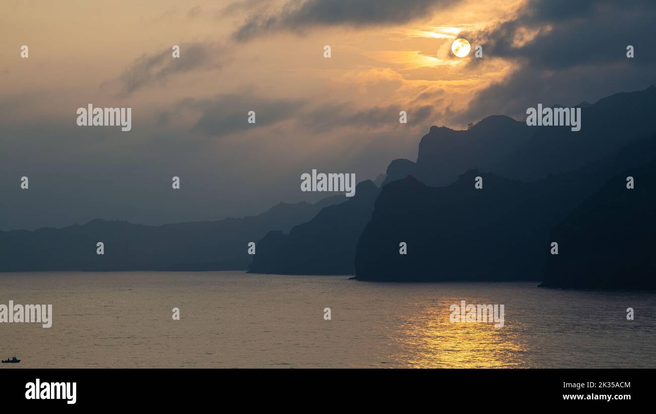 A scenic sunset shot of nature and waterscape on a Hawaiian island ...