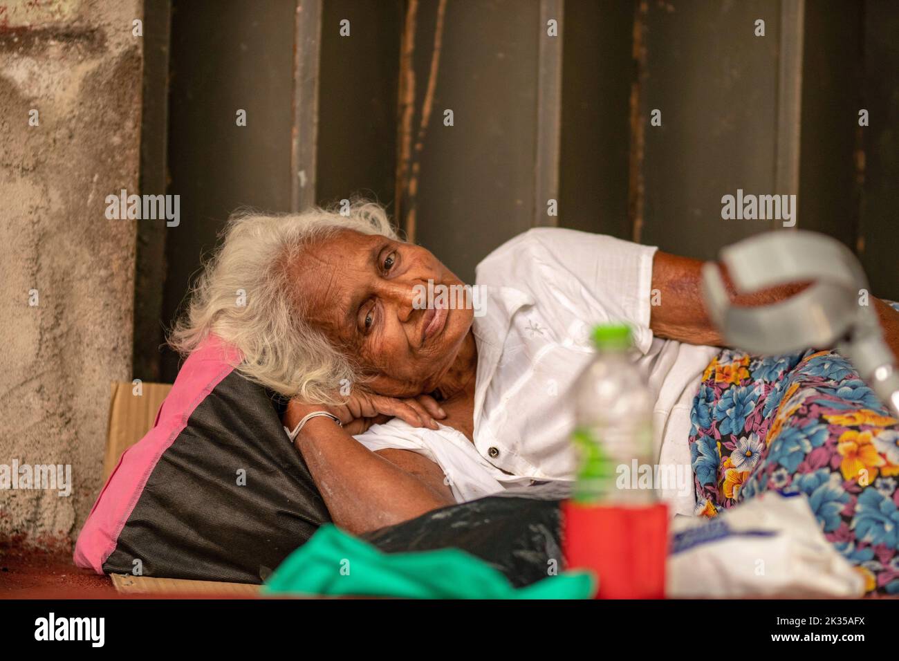 A Poor old lady waiting for her friend return after work Stock Photo ...