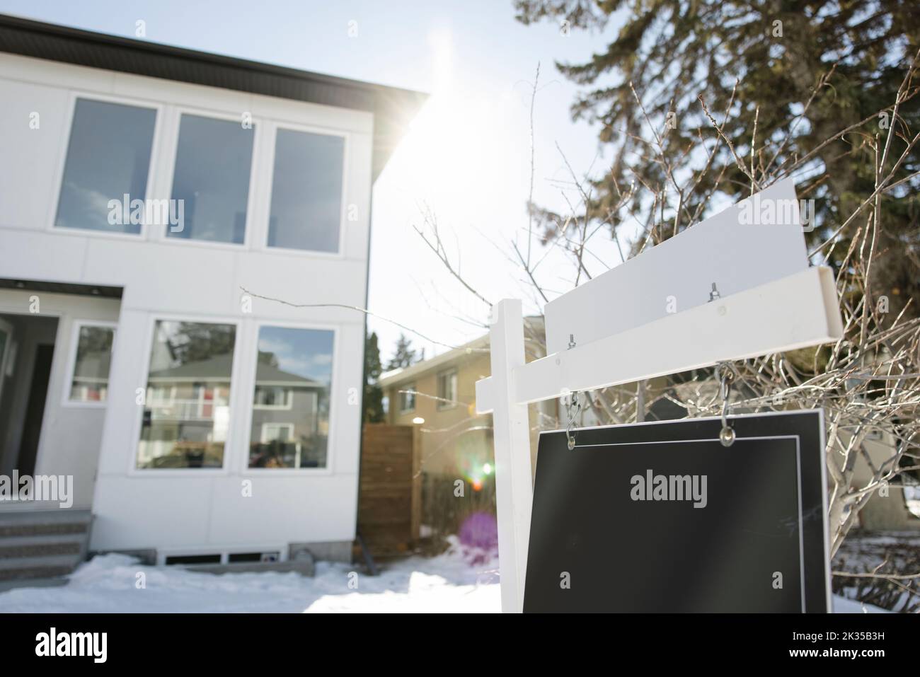For sale sign outside sunny winter newly constructed home Stock Photo ...