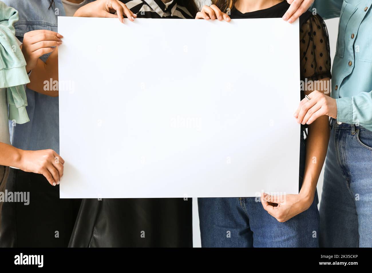 Women holding sheet paper hi-res stock photography and images - Alamy