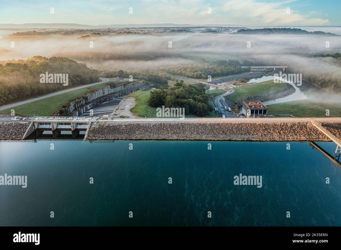 Aerial view of a dam, power station with a foggy sunrise on Tims Ford ...