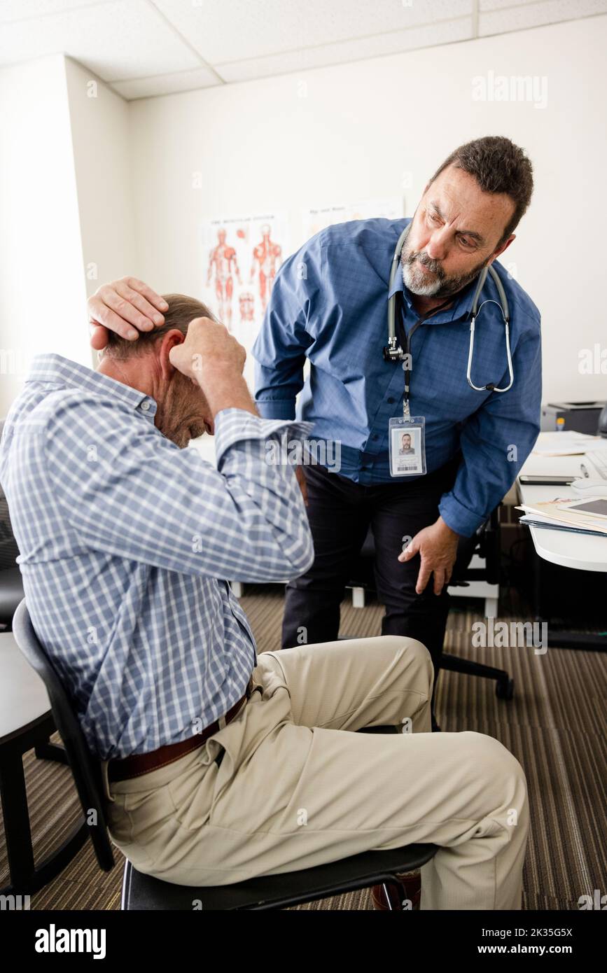 Doctor helping patient hi-res stock photography and images - Alamy