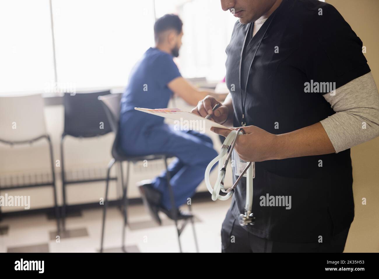Doctor reading chart hi-res stock photography and images - Alamy