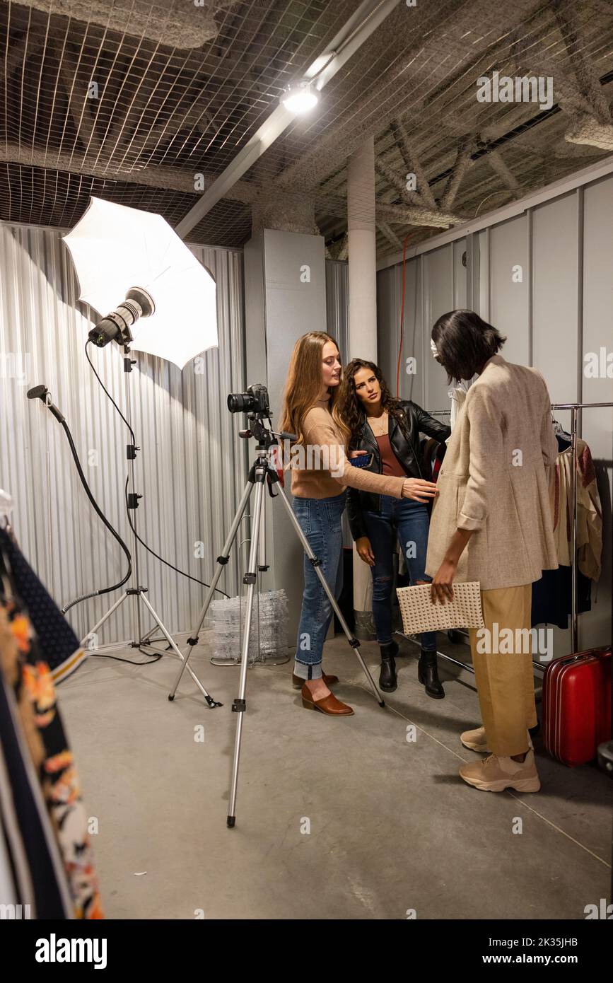 Female fashion model and stylists in storage facility locker Stock ...
