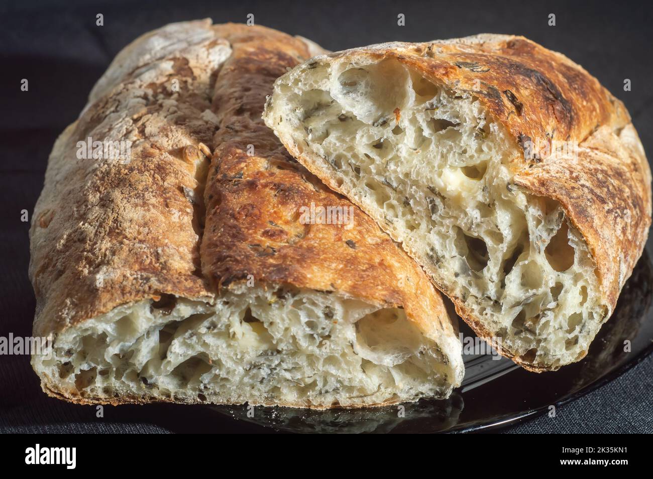 Handmade bread with natural fermentation placed on a black dish Stock ...