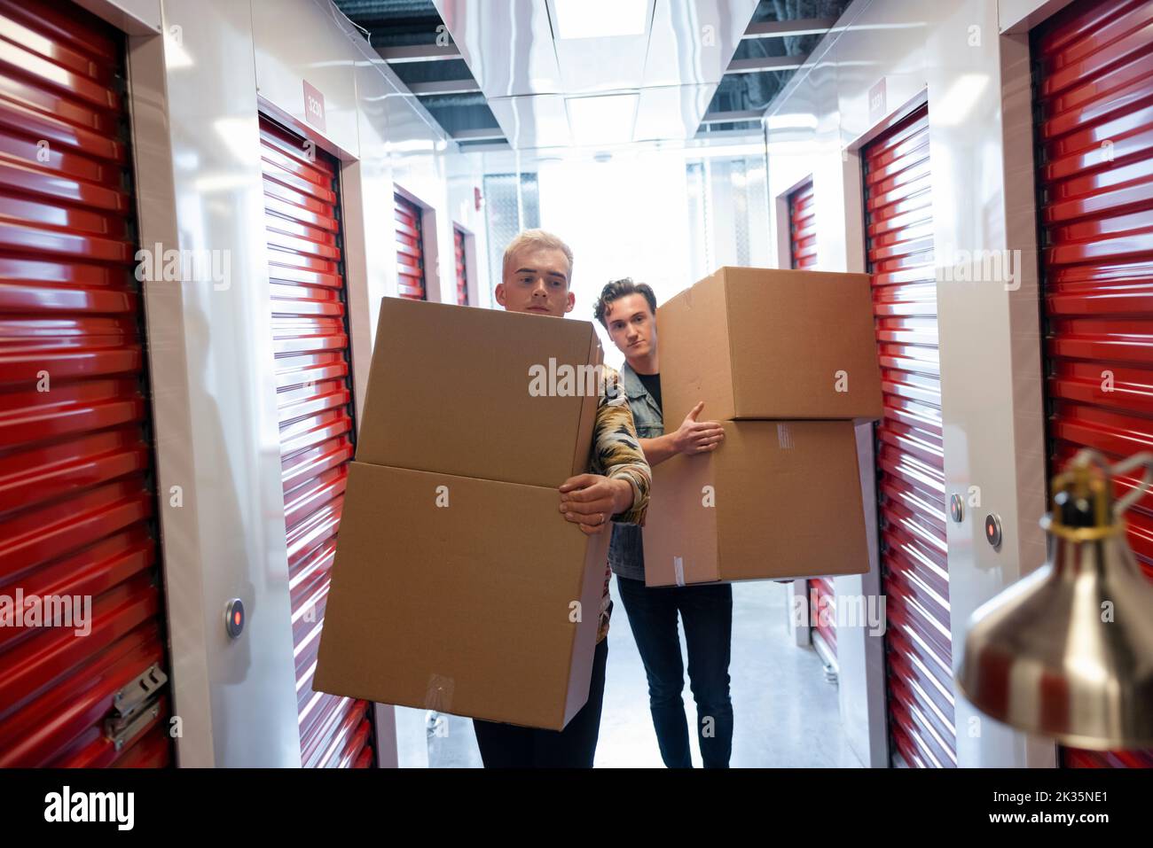 Two men carrying boxes hi-res stock photography and images - Alamy