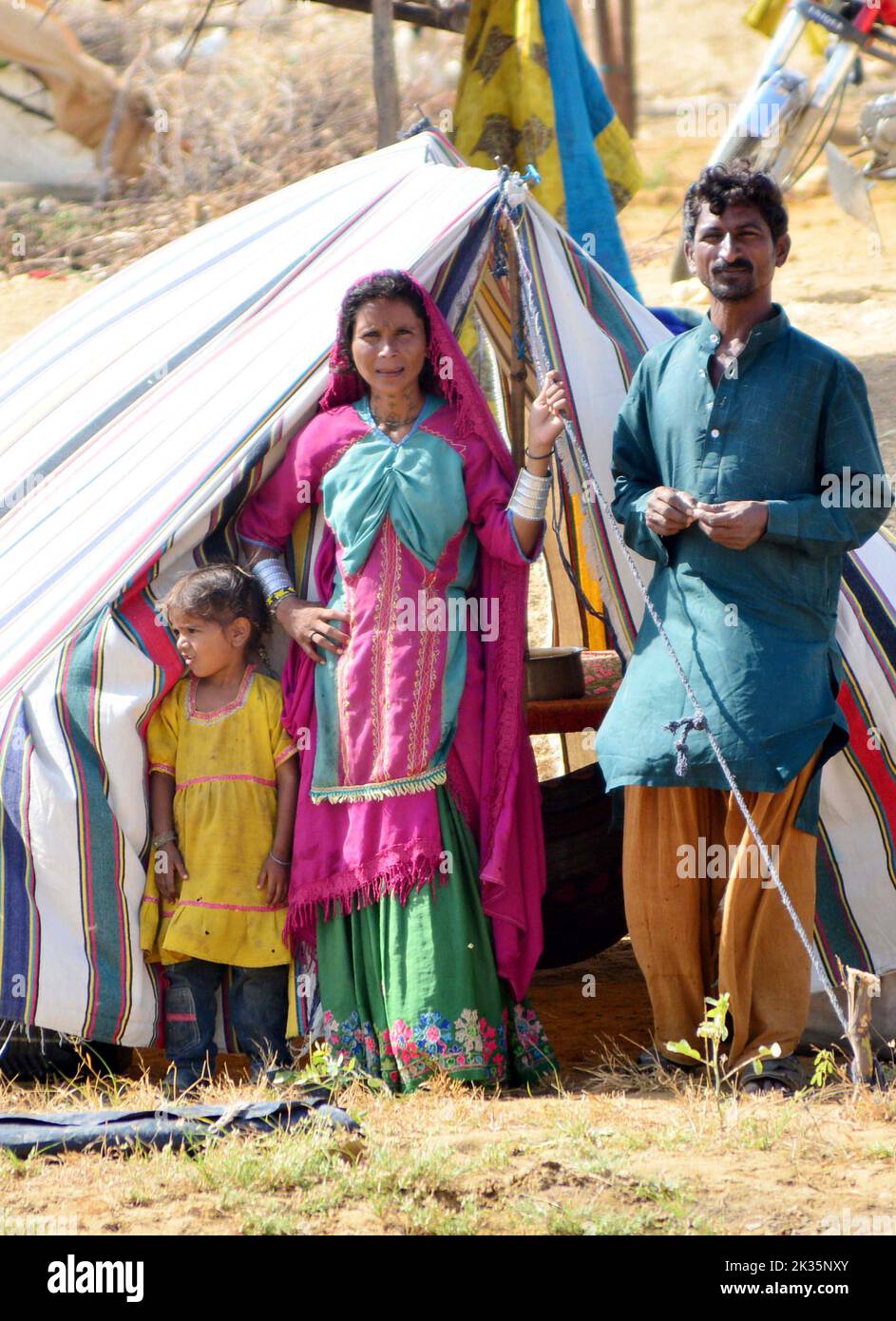 Hyderabad. 24th Sep, 2022. A flood-affected family stand outside a ...