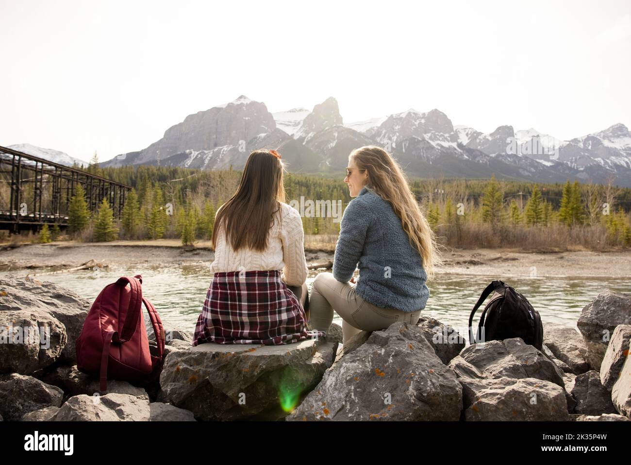 Back view two friends sit hi-res stock photography and images - Alamy