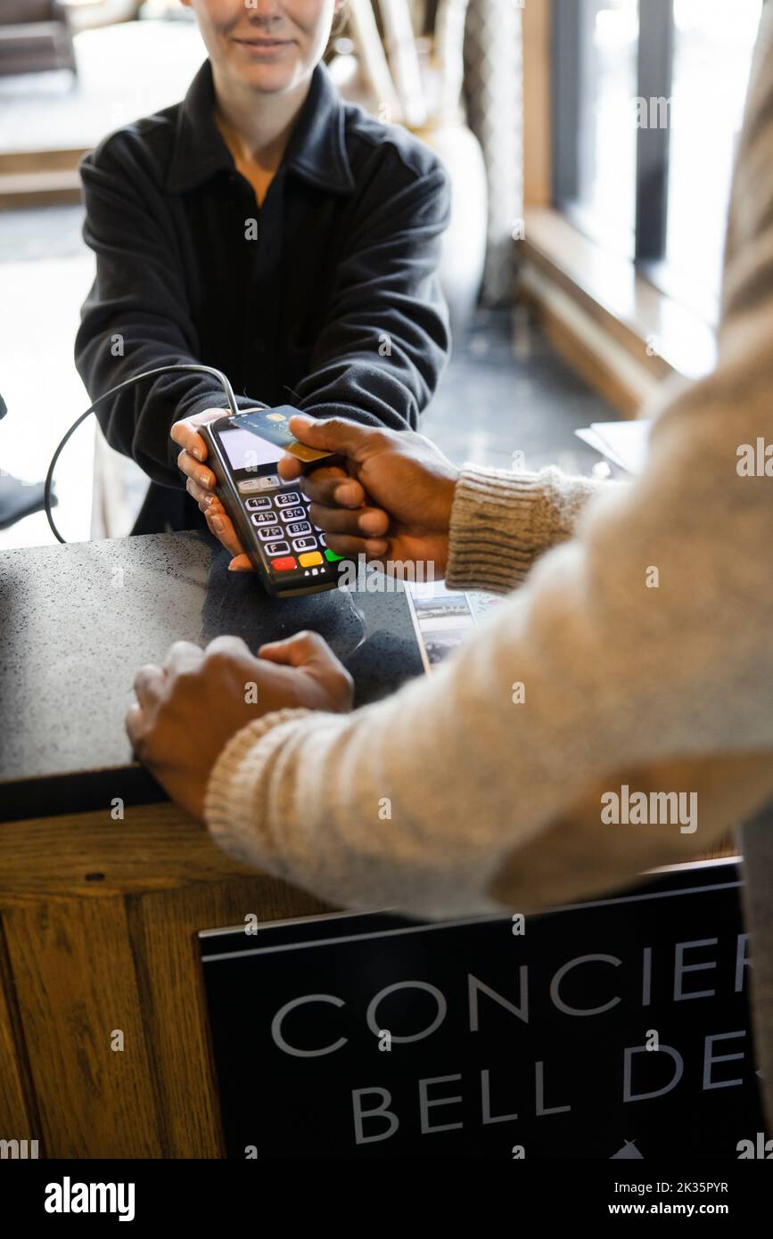 Man paying bill in hotel Stock Photo - Alamy