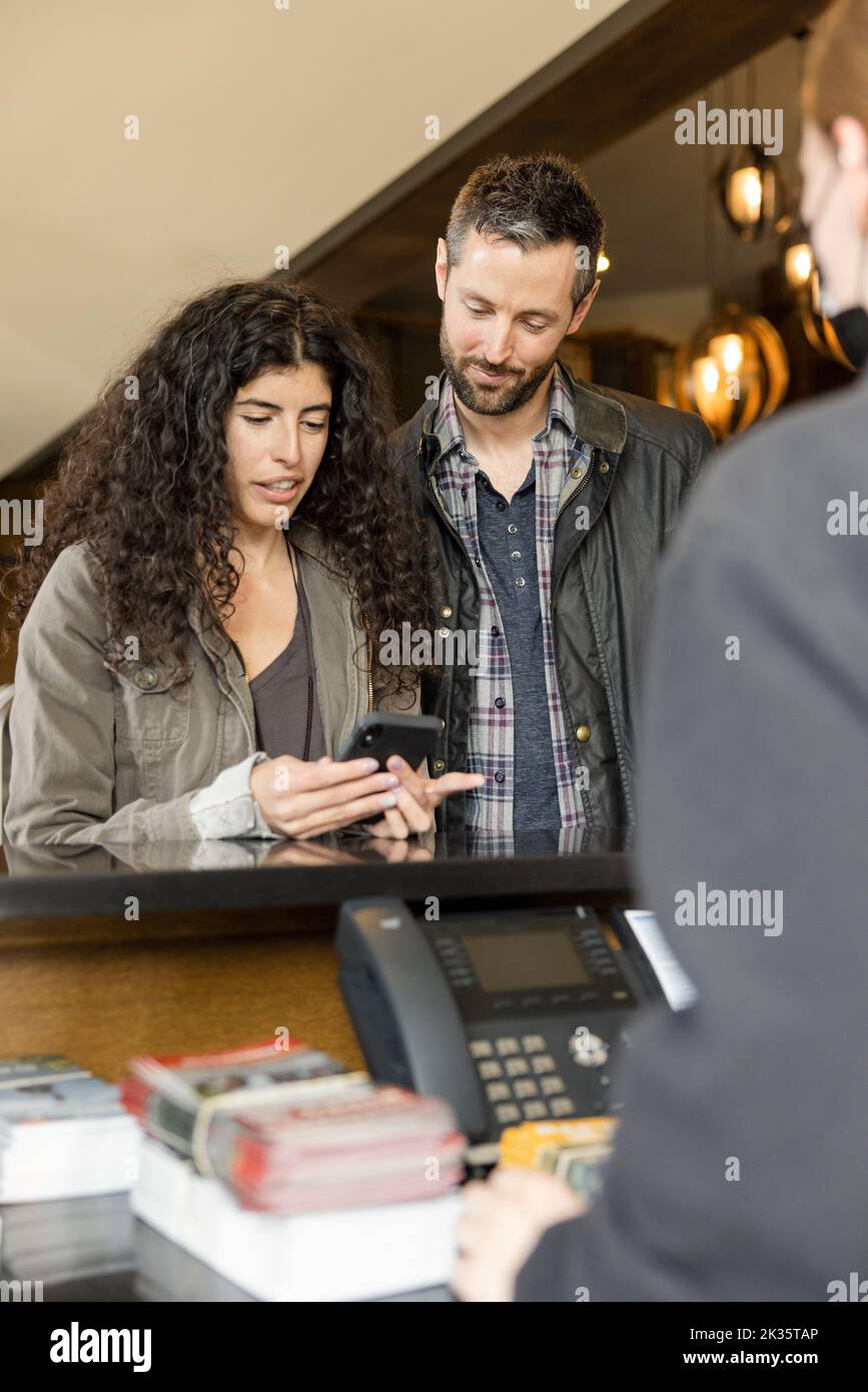 Checking in hotel reception hi-res stock photography and images - Alamy