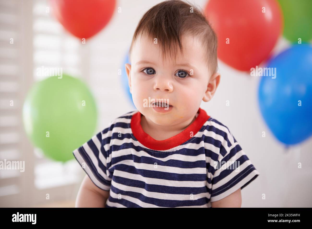 Looking smart on his special day. a baby boy sitting at home with ...