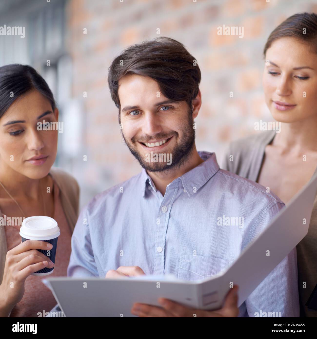 The number one team in the business. three young colleagues in their ...