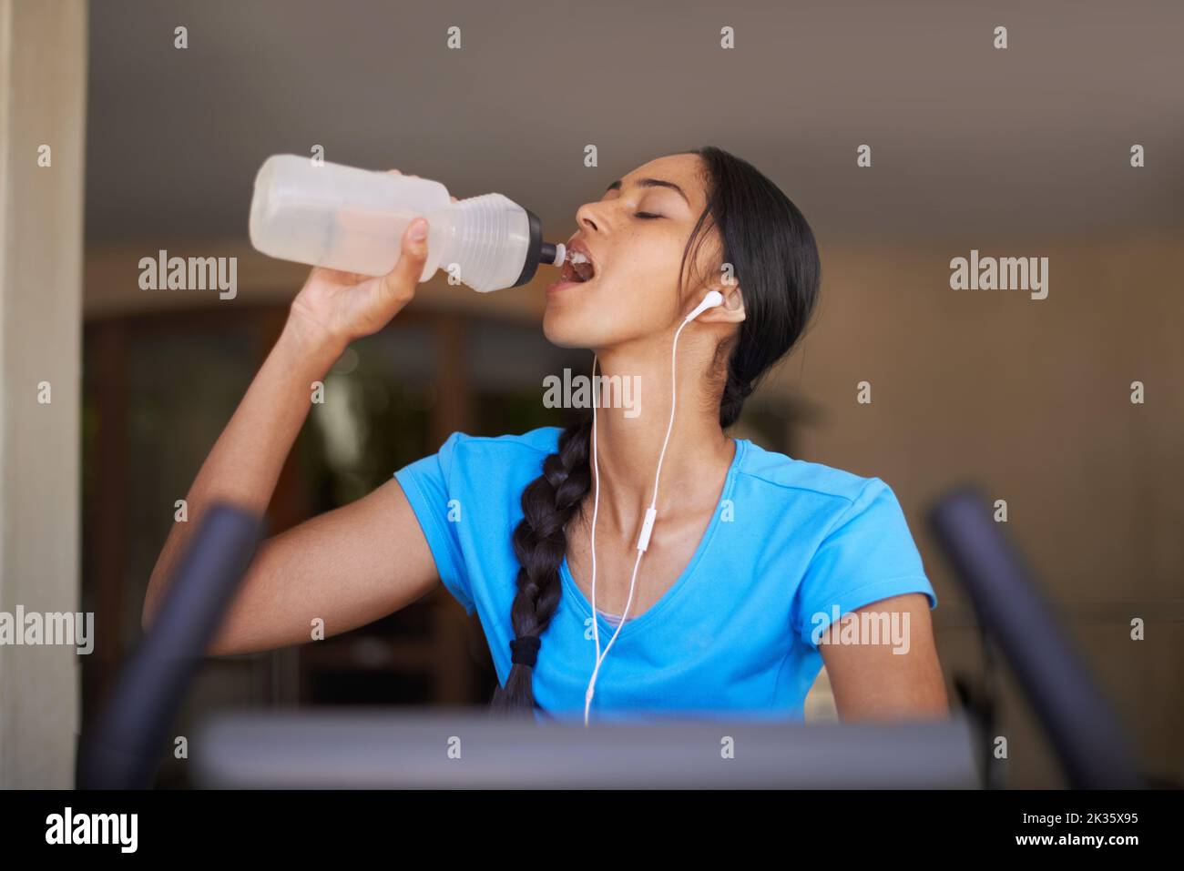 Staying hydrated is important. A teenager on an exercise bike at the ...