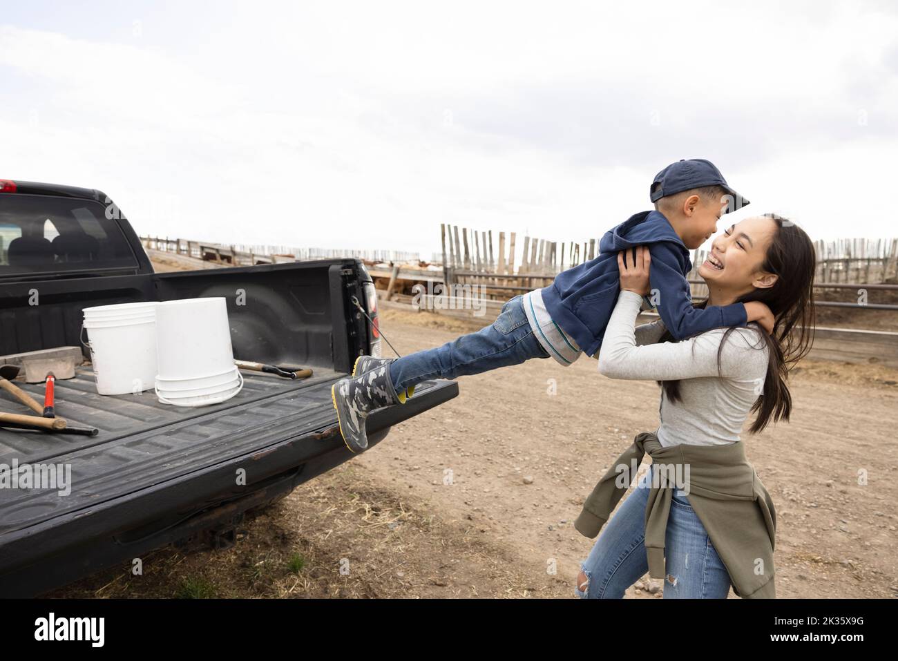 Happy brother jumping into arms of sister on rural farm Stock Photo - Alamy