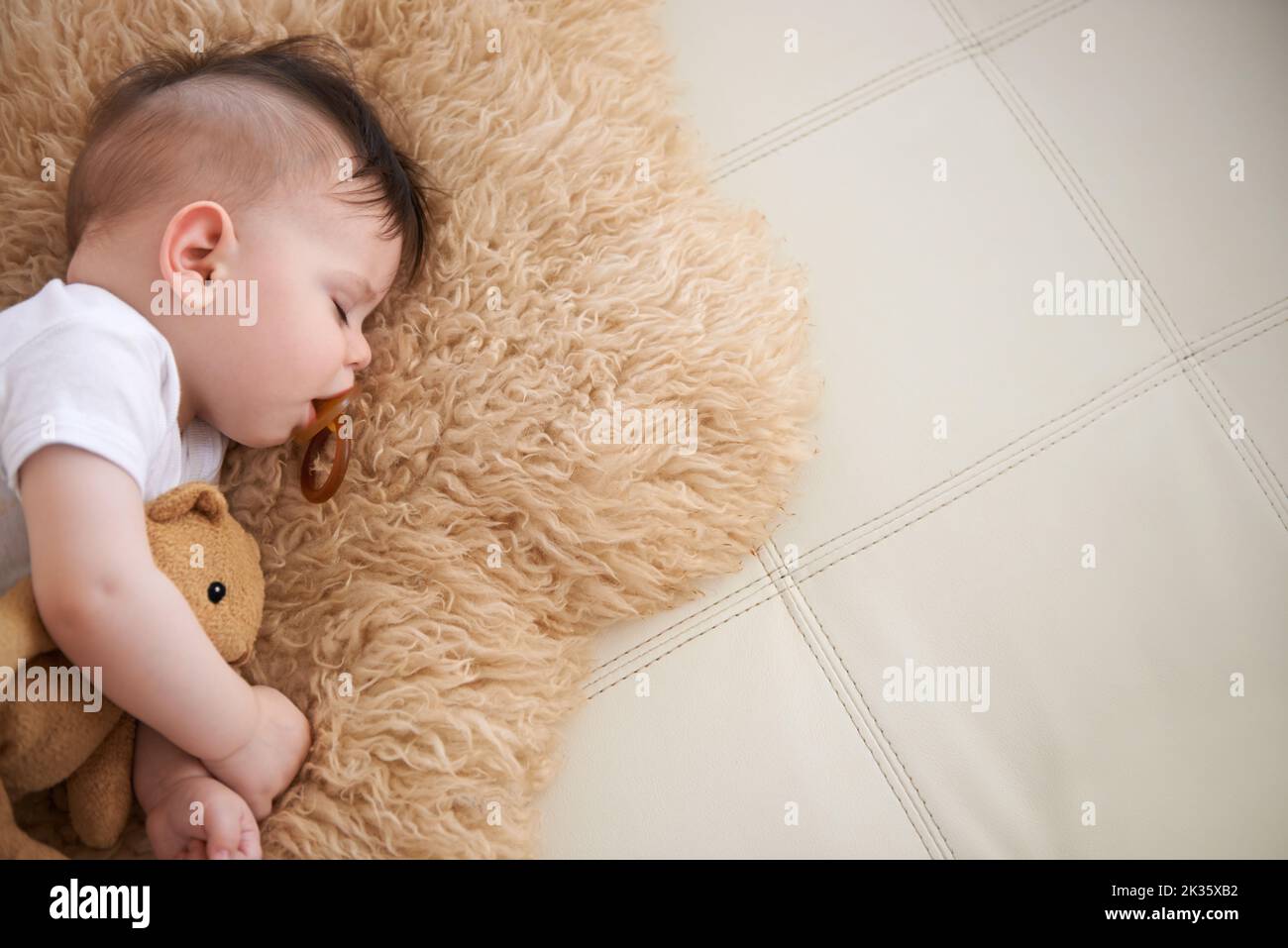 He always naps after feeding. an adorable baby boy taking a nap Stock ...