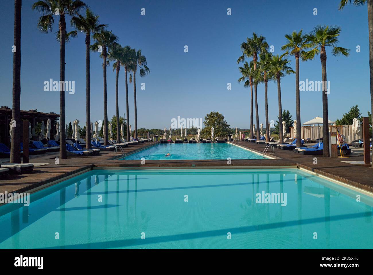 Swimming pool with palm trees on the side in a hotel in Algarve ...