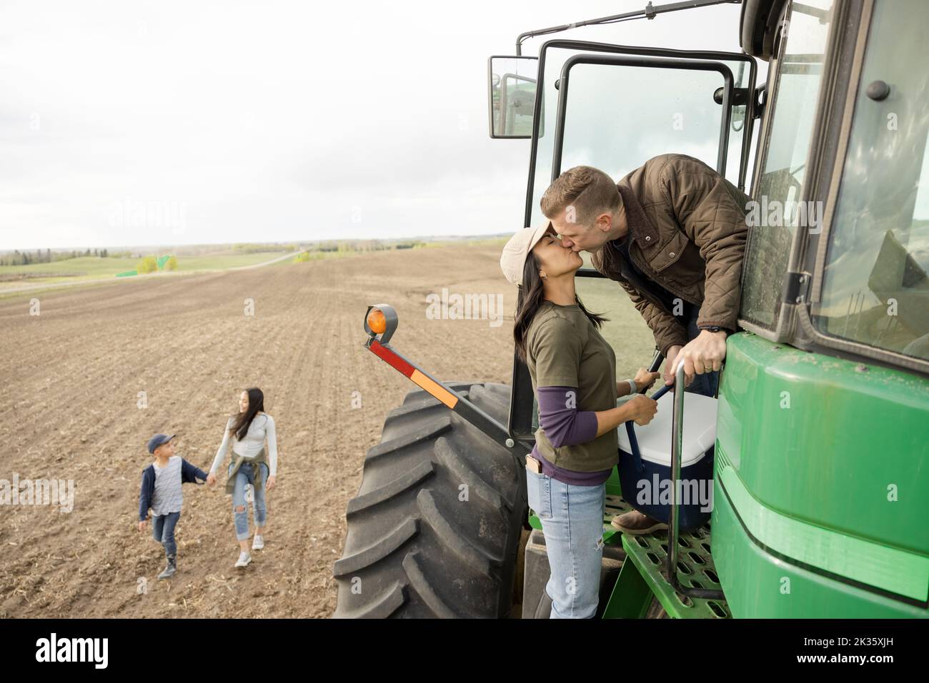 Affectionate farmer couple kissing at tractor on rural farm Stock Photo - Alamy