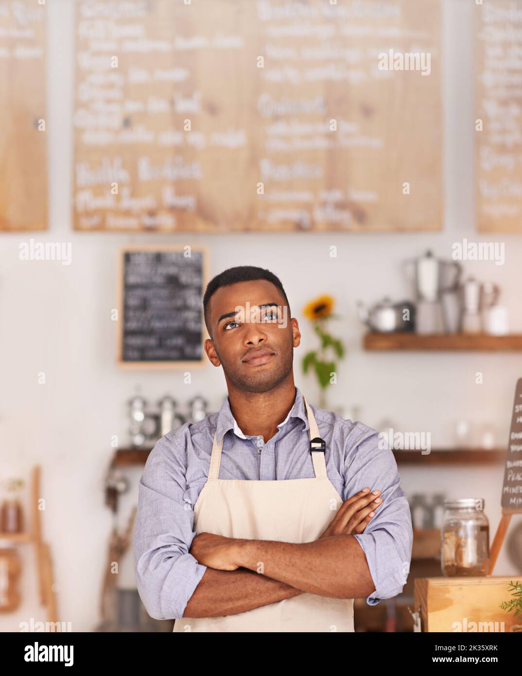 Thinking about the latest in coffee trends. a thoughtful young barista ...
