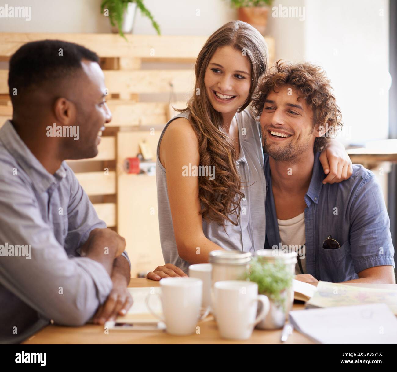 Catching up with old friends. a group of friends talking in a cafe ...