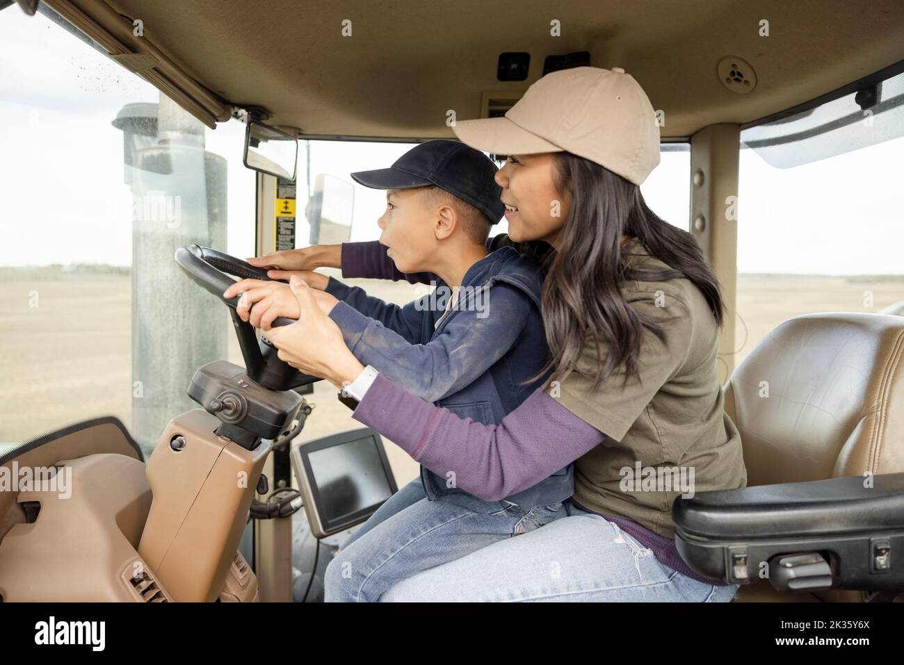 Mother and son driving tractor hi-res stock photography and images - Alamy