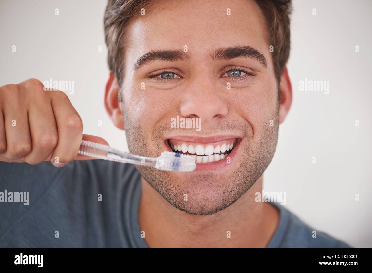 Keeping his teeth sparkly white. a man brushing his teeth Stock Photo - Alamy