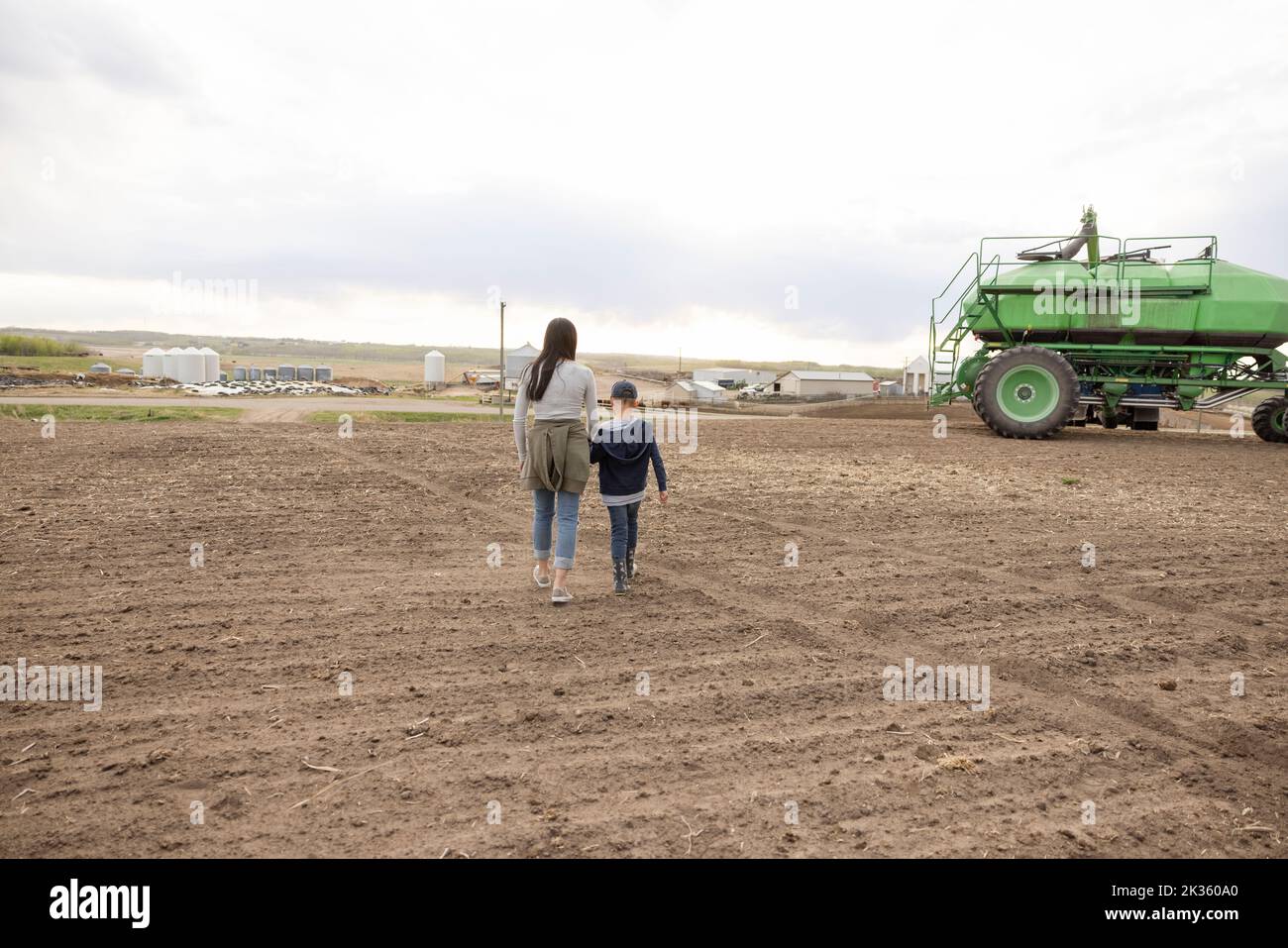 Brother and sister farmers walking in rural farm field Stock Photo - Alamy