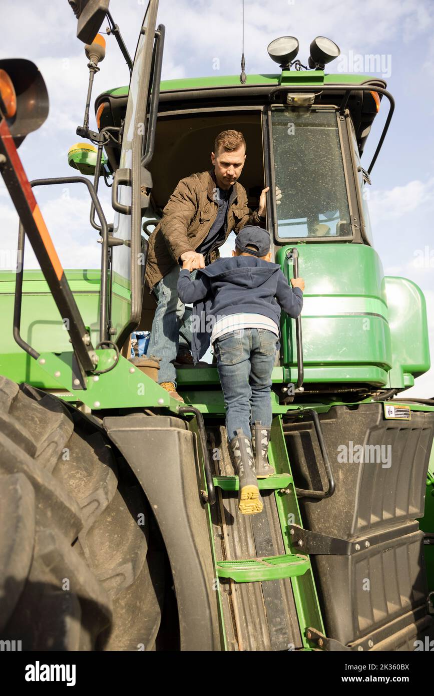 Man climbing tractor hi-res stock photography and images - Alamy