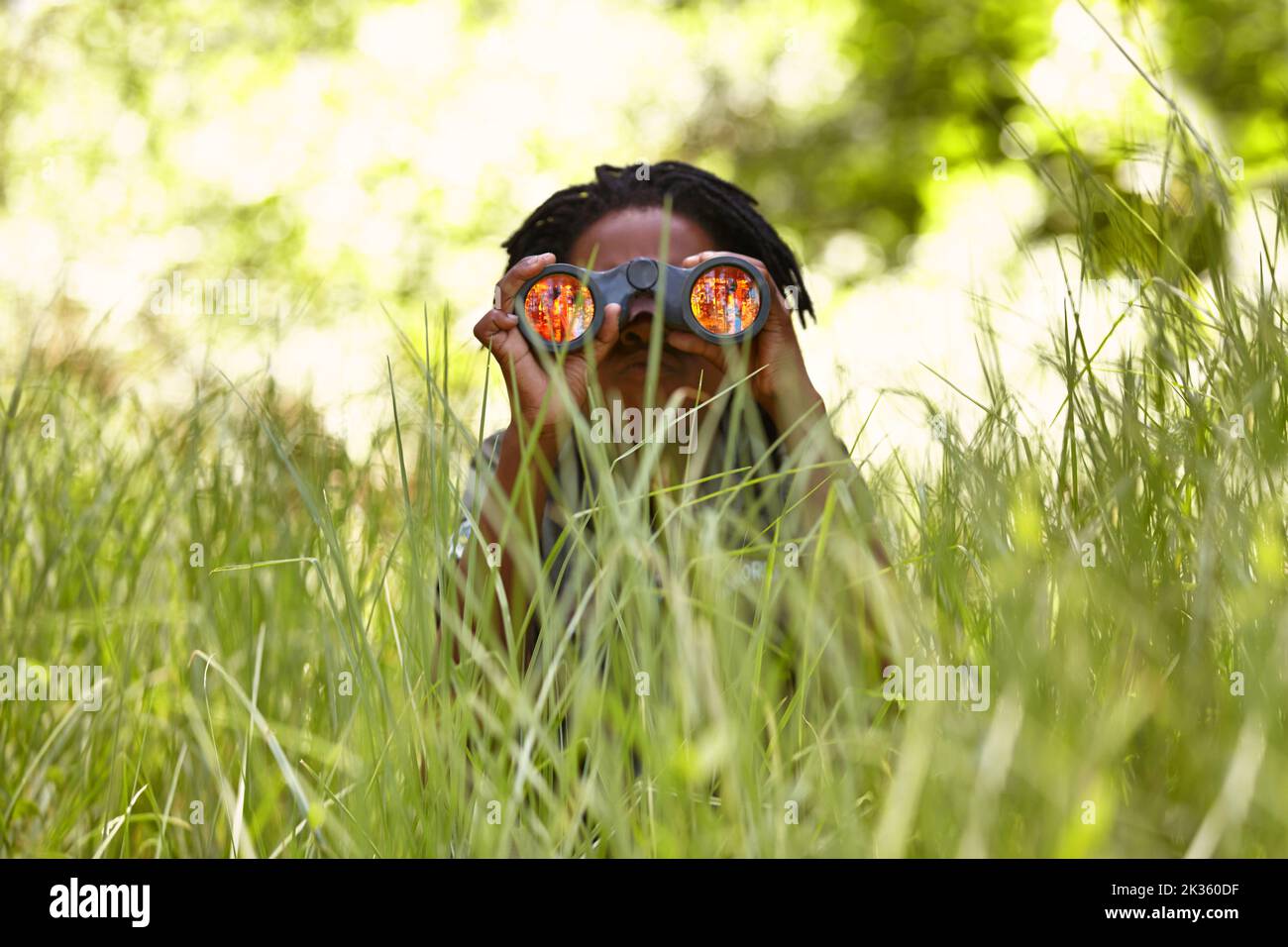Undercover spy training in the fields. A young boy enjoying nature with ...