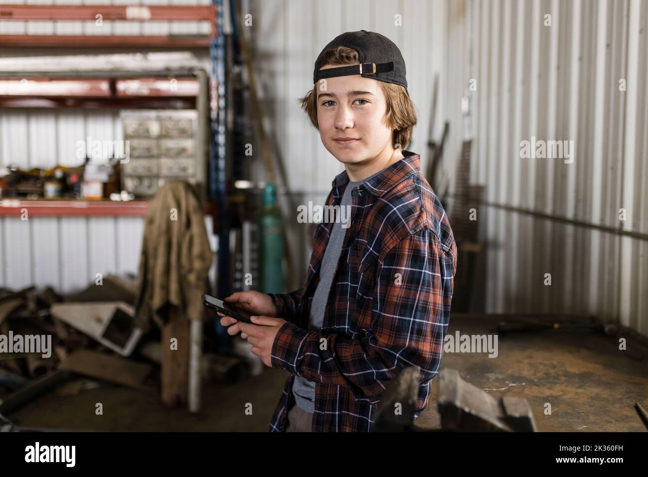 Handsome boy standing holding phone hi-res stock photography and images ...