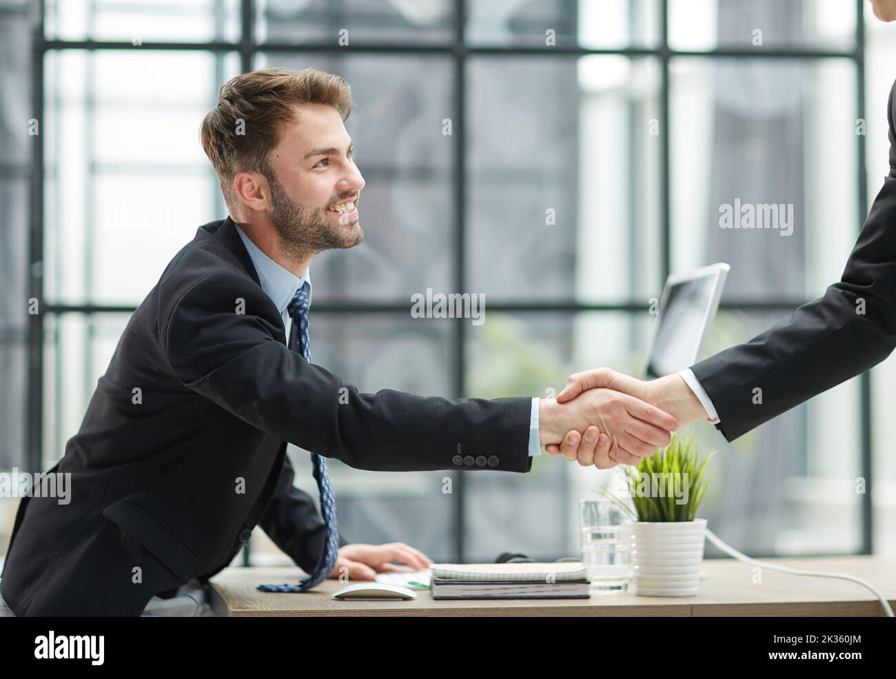 Portrait of cheerful young manager handshake with colleague Stock Photo ...