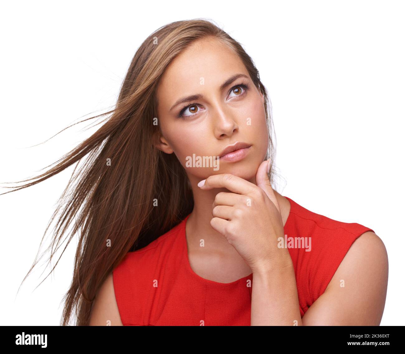 Deep in thought. an attractive young woman looking thoughtful isolated ...